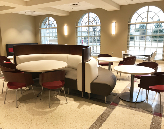 Cafe with comfortable banquette seating and wood privacy screens ...